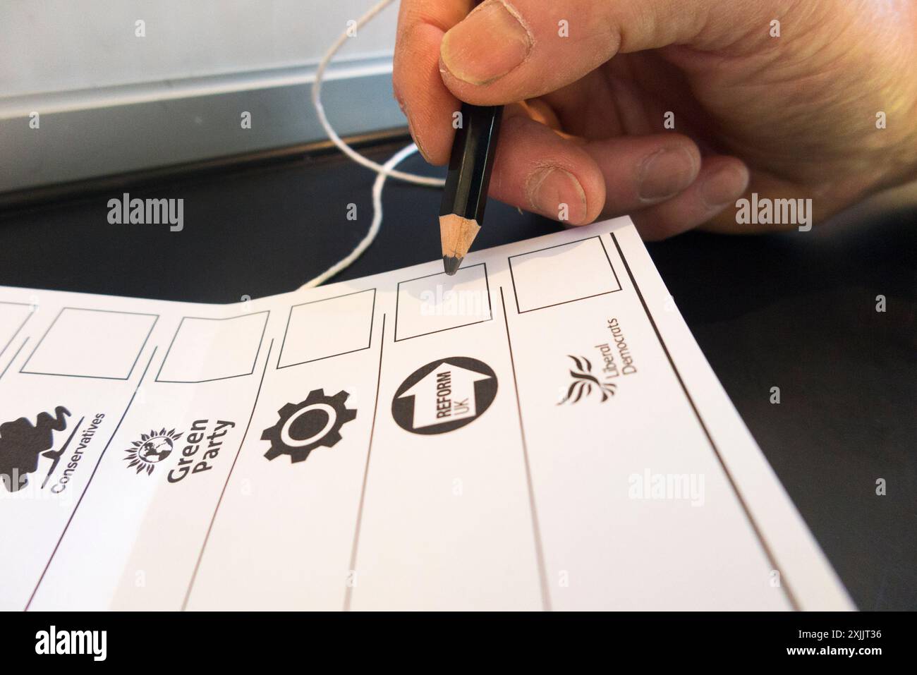 Ballot paper and pencil as voter makes choice to cast a vote and make a ...