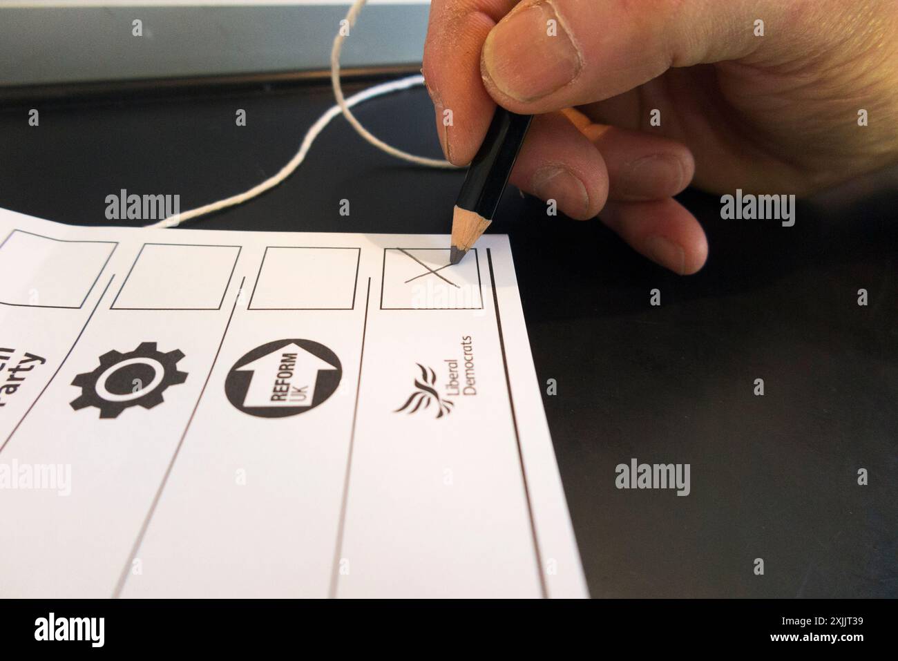 Ballot paper and pencil as voter makes choice to cast a vote and make a ...