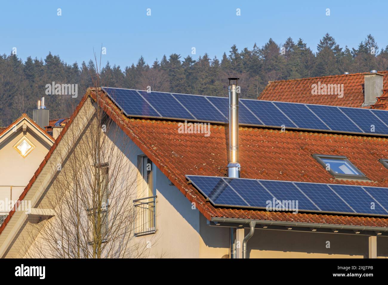 detached house with solar panels on the roof and stainless steel ...
