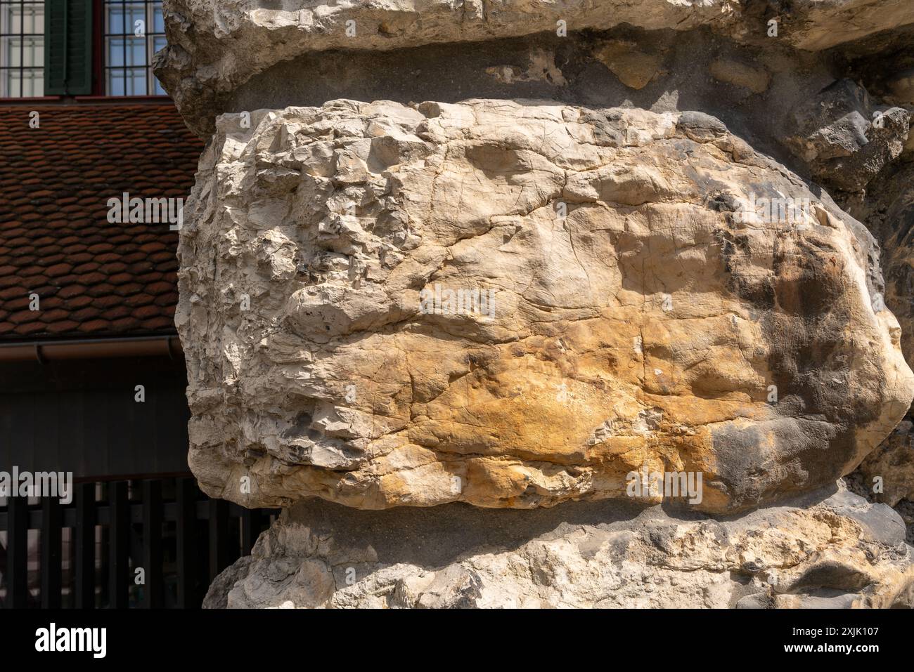 Texture of big limestone boulder which is part of a stone wall of an ...