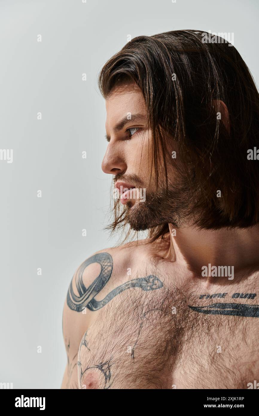 Handsome Caucasian man showcasing chest tattoos and long hair Stock ...