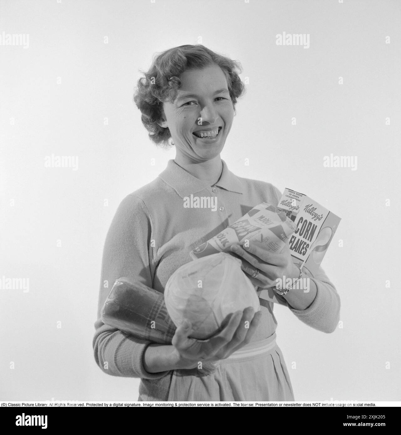 In the 1960s. A woman with groceries. The classic Tetran milk package ...