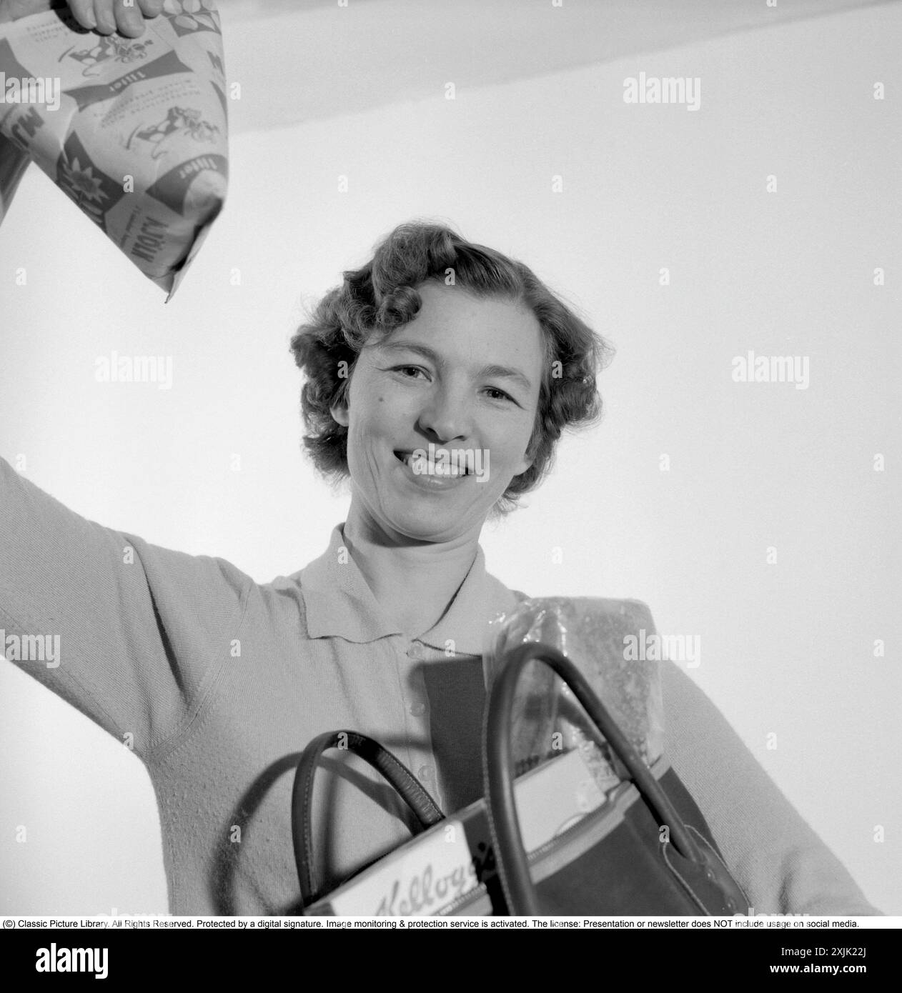 In the 1960s. A woman with her shopping bag. The classic Tetran milk ...