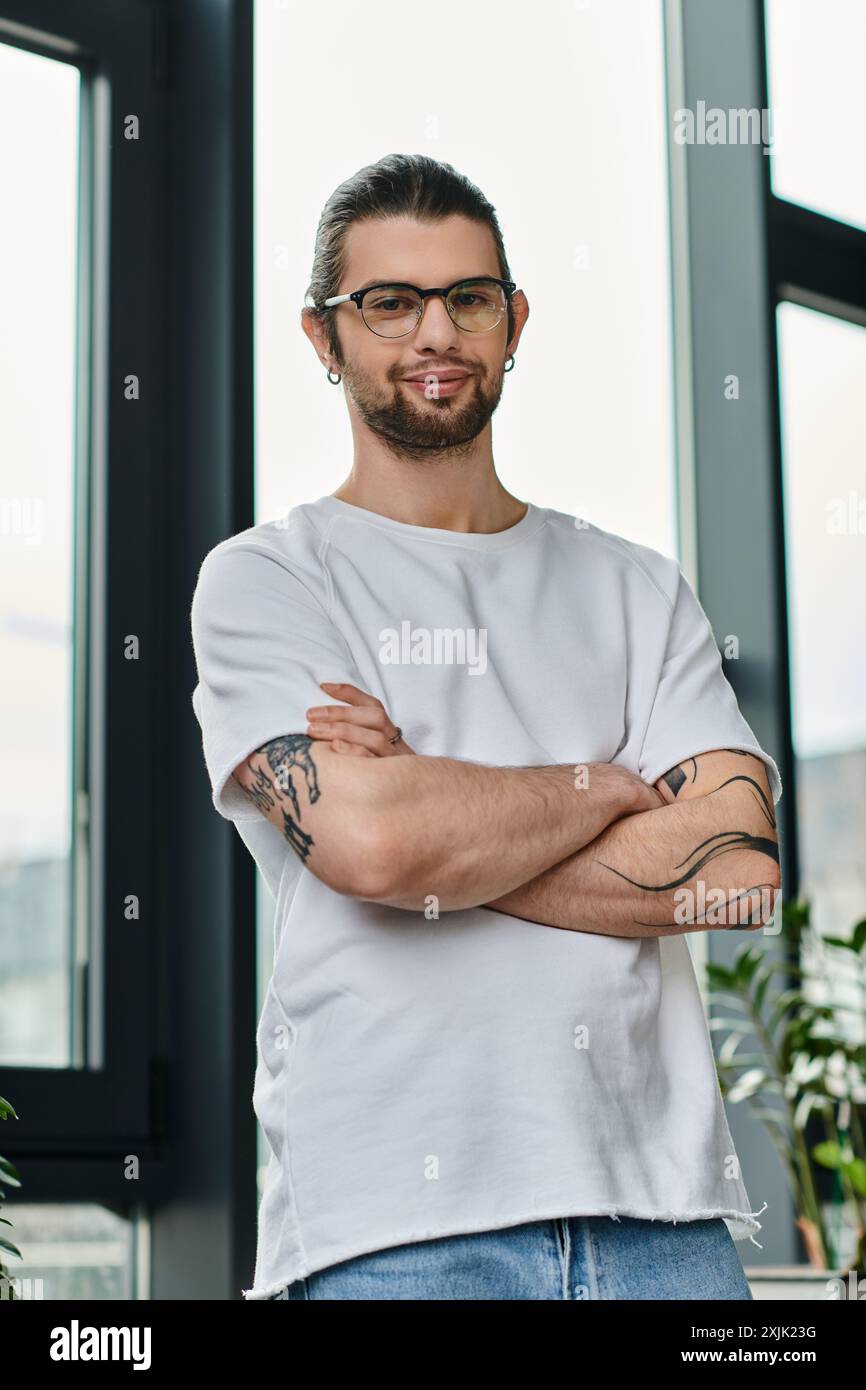Bearded man with glasses stands arms crossed in assertive pose Stock ...