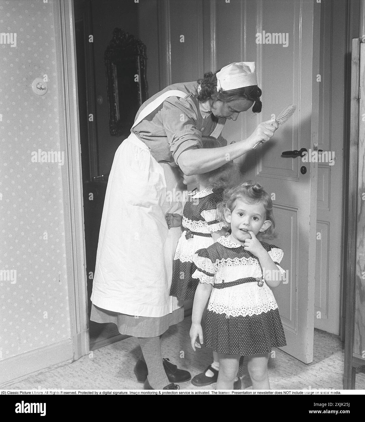 Maid 1949. A young woman employed as a nanny and maid is in the kitchen ...