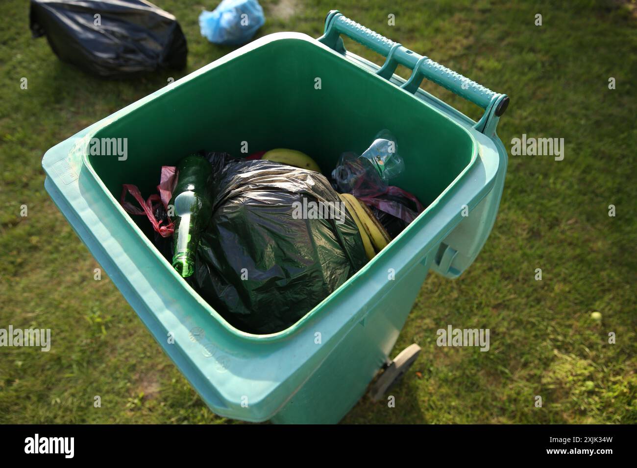 Trash bags full of garbage in bin outdoors, closeup Stock Photo - Alamy