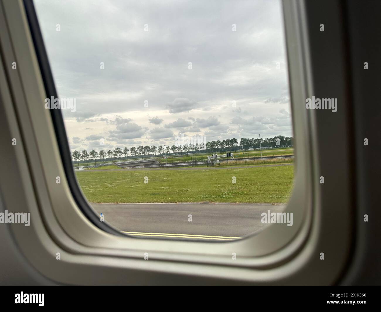 View on runway and surroundings through plane window Stock Photo - Alamy