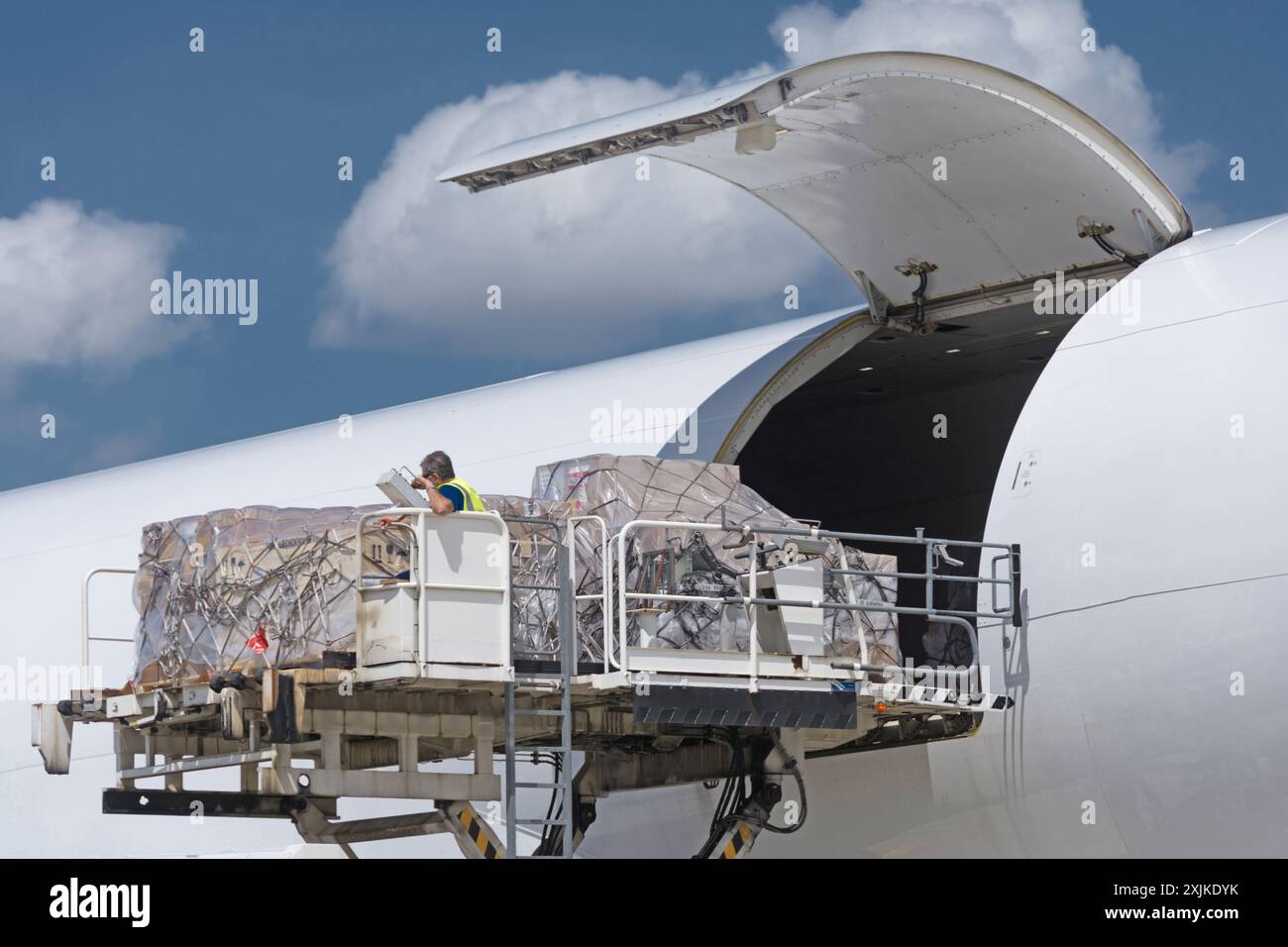 Close-up of airplane being loaded with air cargo Stock Photo - Alamy