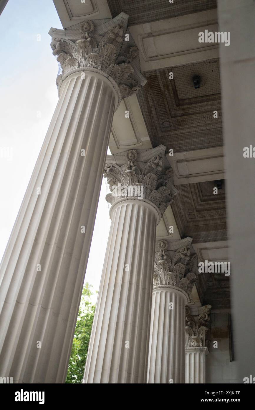 A close-up view of ornate Corinthian columns supporting a detailed ceiling structure at the ...