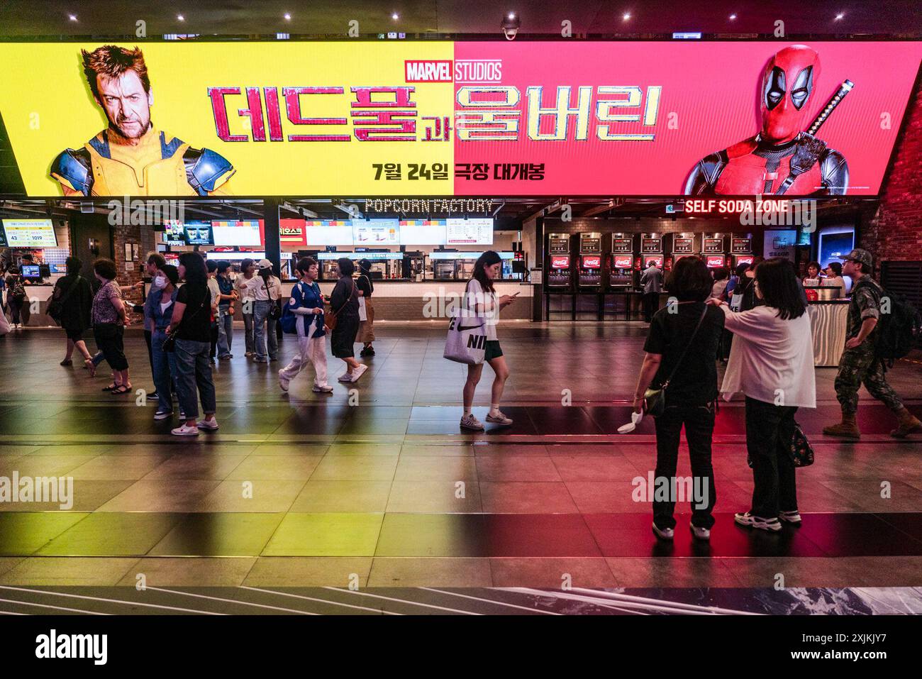 Seoul, South Korea. 19th July, 2024. People walk past a billboard of ...