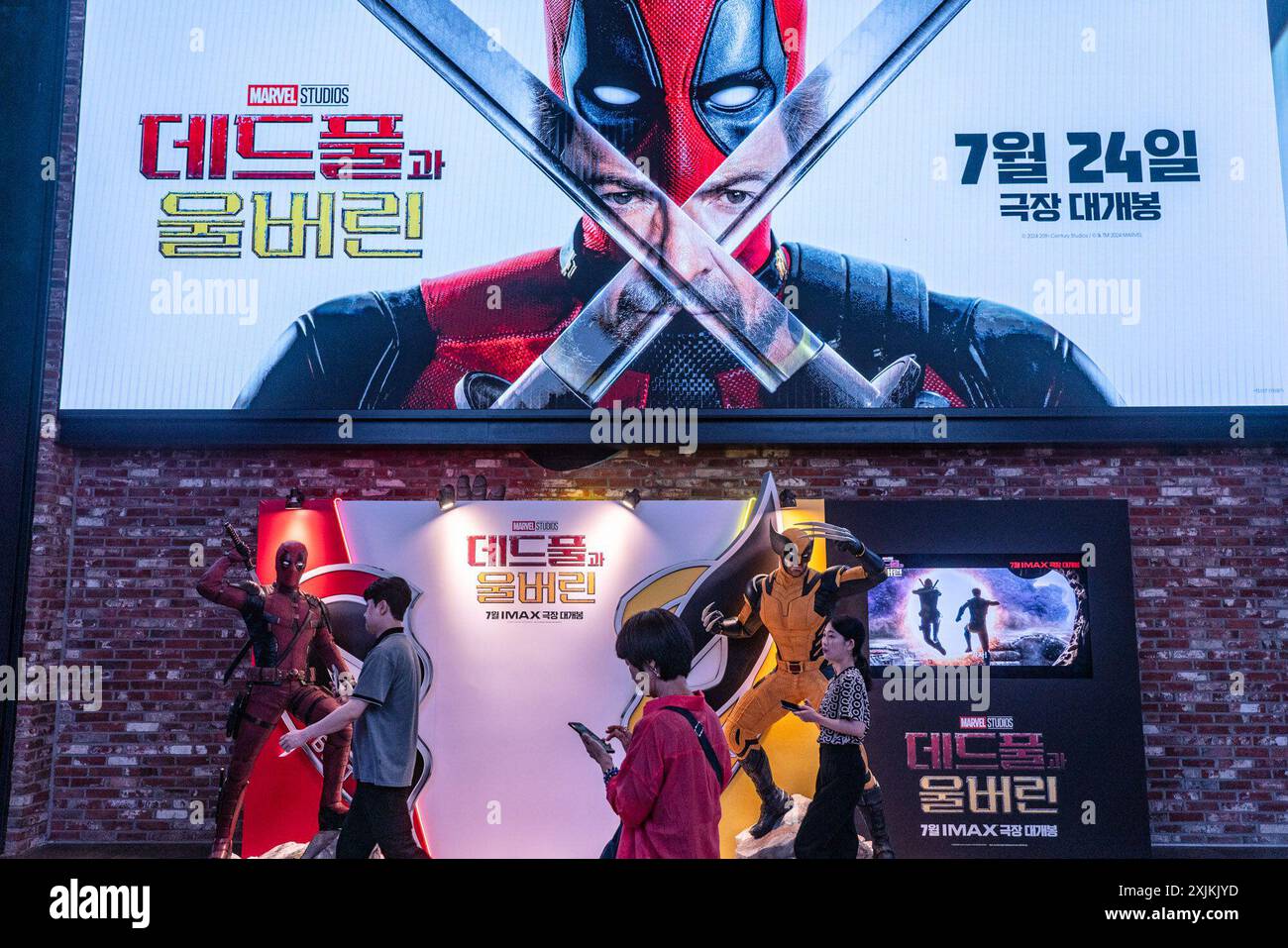 Seoul, South Korea. 19th July, 2024. People walk past a billboard of ...