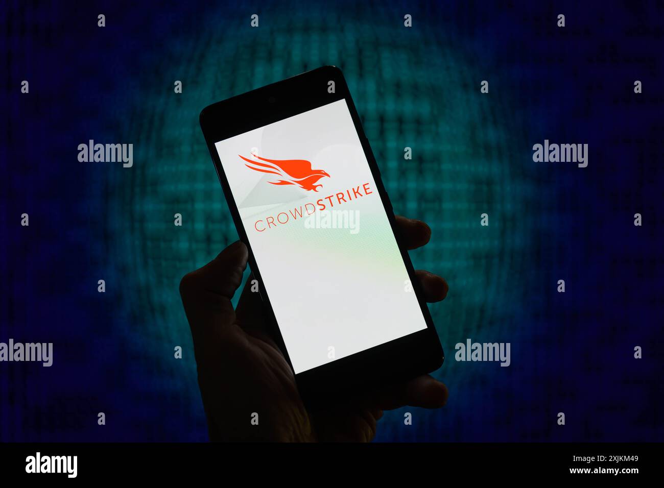 The CrowdStrike logo is being displayed on a smartphone in this photo ...