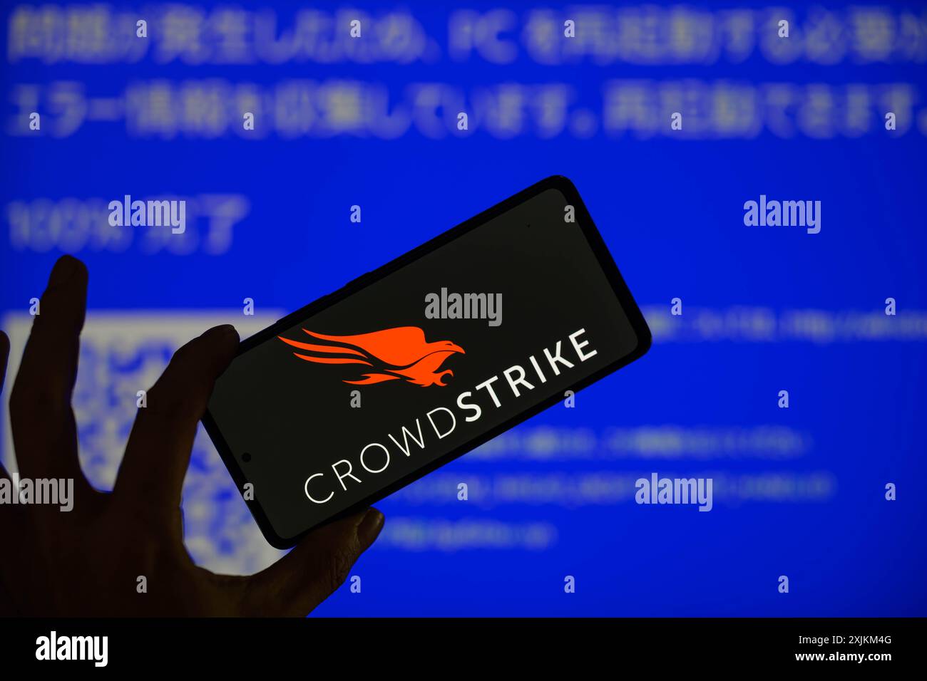 The CrowdStrike logo is being displayed on a smartphone in this photo ...