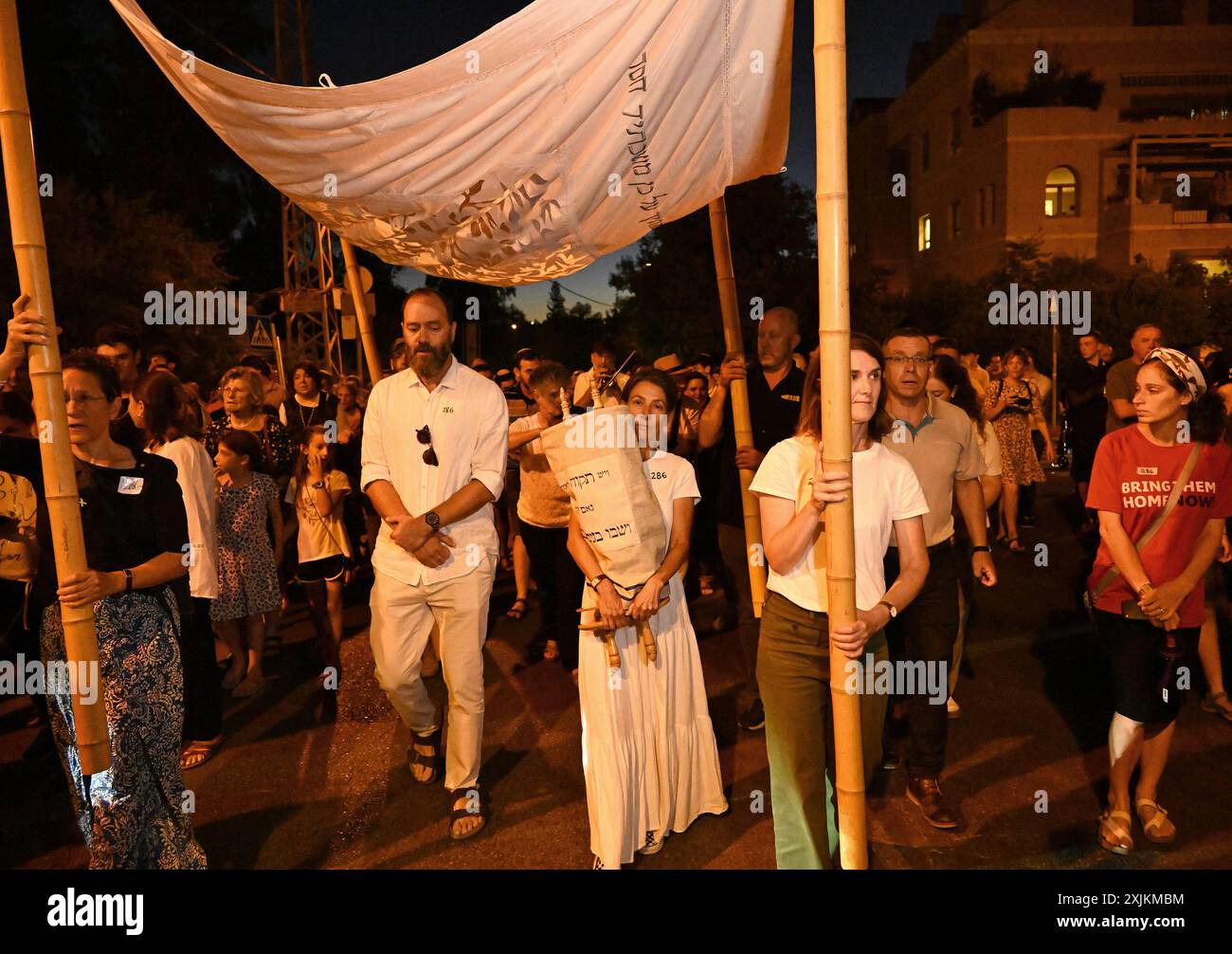 Jon Polin (L) walks beside Rachel Goldberg-Polin (R), the parents of ...