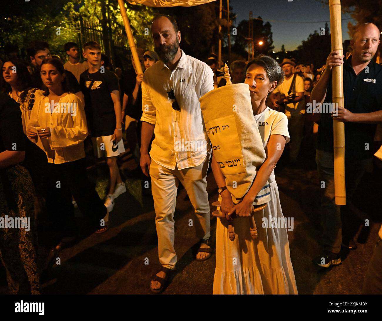 Jon Polin (L) walks beside Rachel Goldberg-Polin (R), the parents of ...