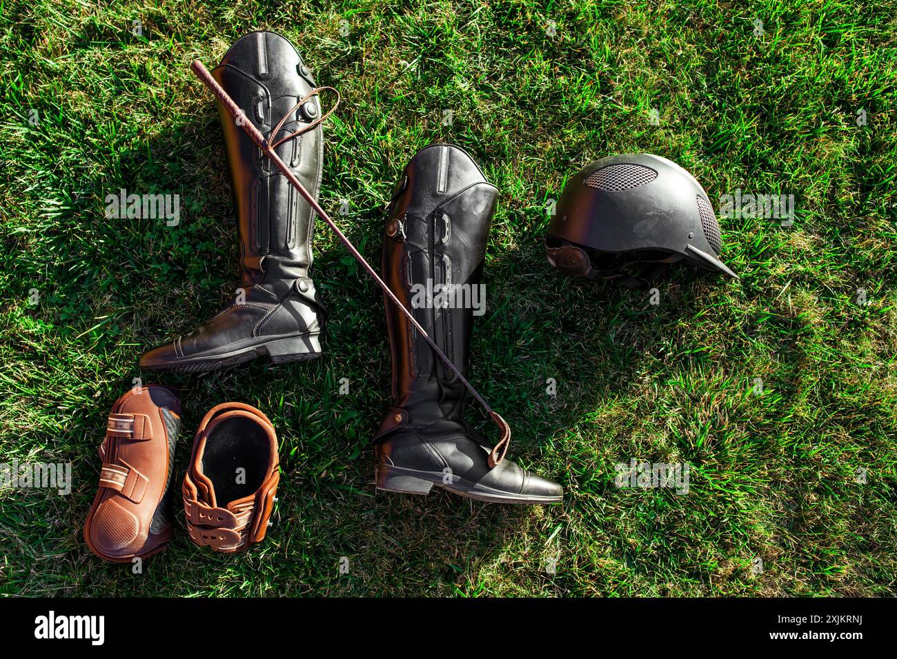 flat lay shot of equestrian horse riding equipment with helmet, leather ...