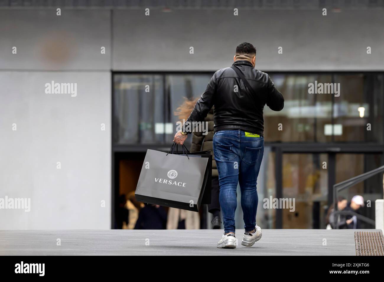 Consumer tourist lugging shopping bags, factory outlet, Outletcity ...