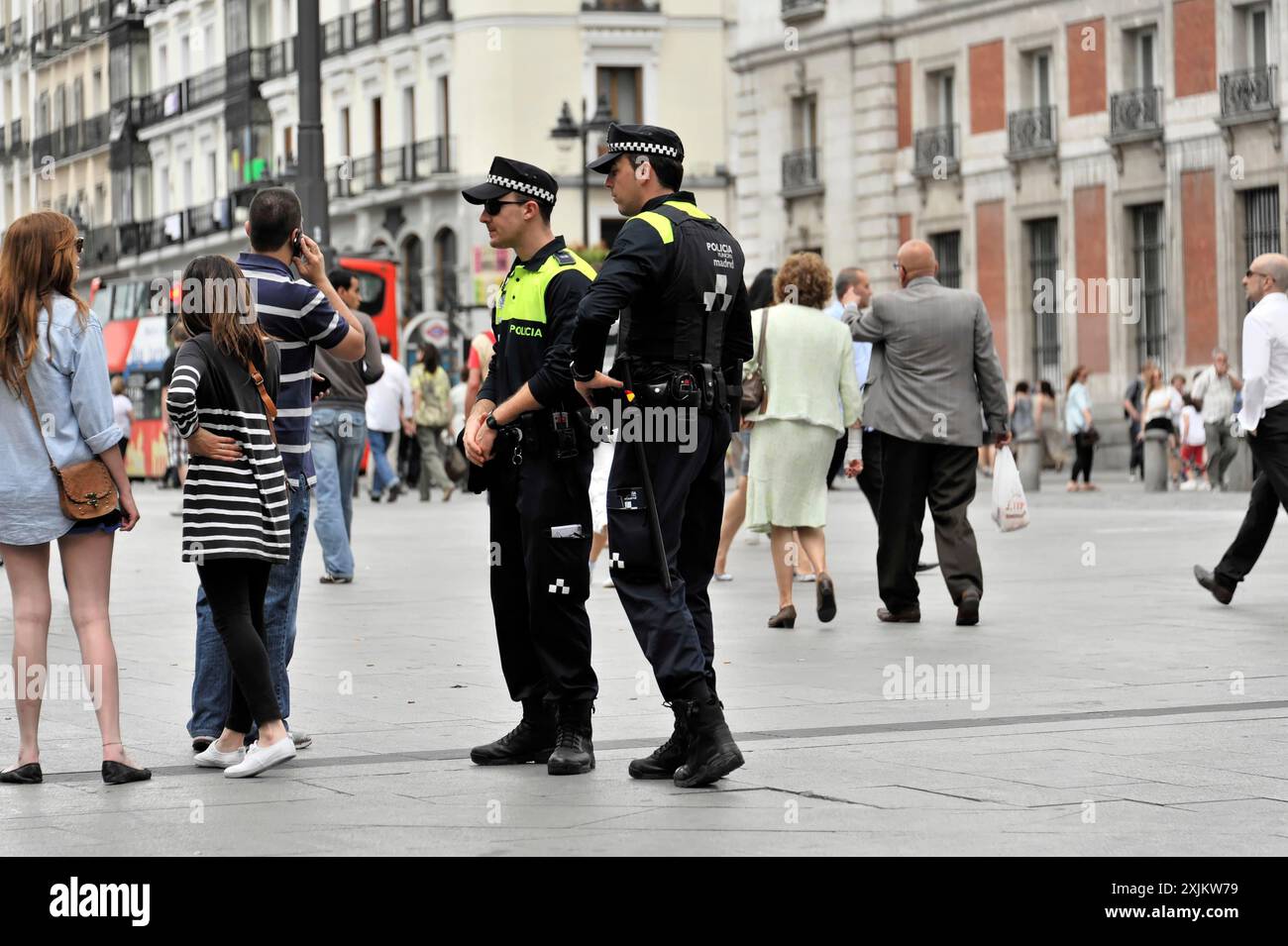 Madrid, Spain, Europe, Police officers in uniforms talking to passers ...