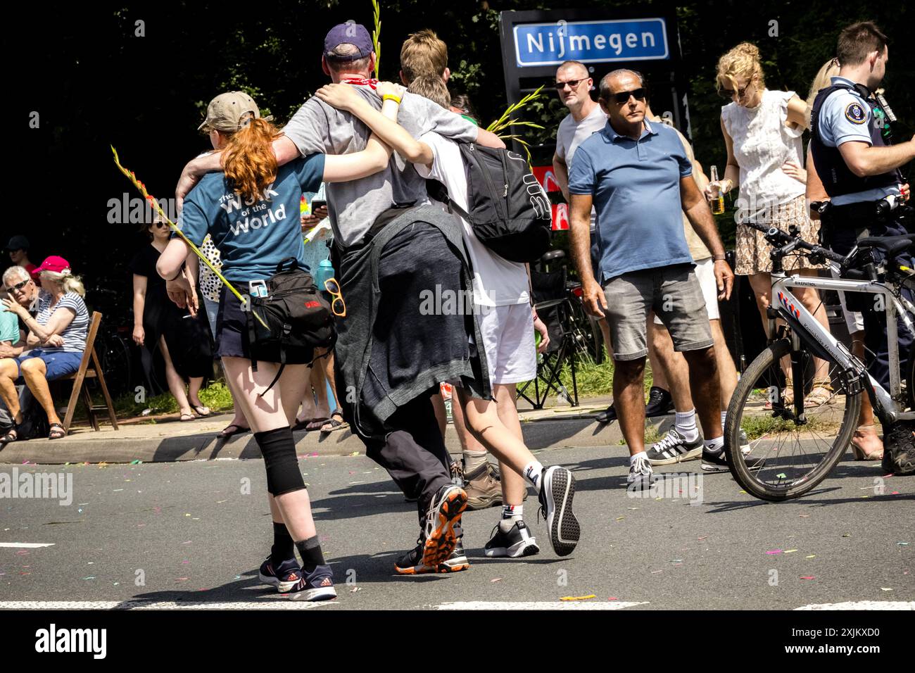 NIJMEGEN - 19/07/2024 Walkers walk across the finish line at the Via ...