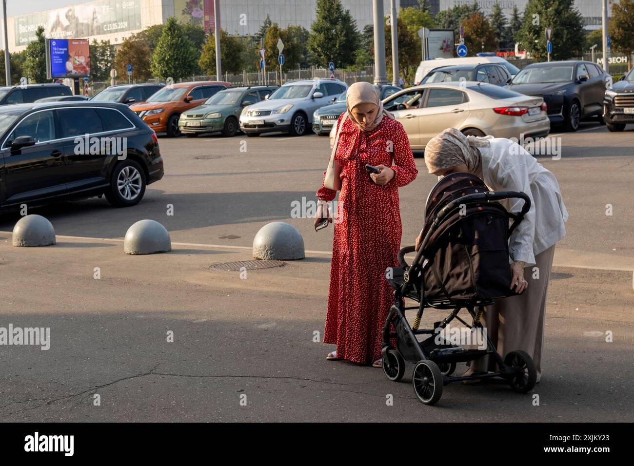 Moscow, Russia - July 16, 2024, Two girls in hijabs and a red dress ...