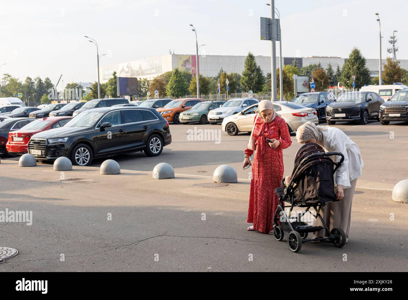Moscow, Russia - July 16, 2024, Two girls in hijabs and a red dress ...