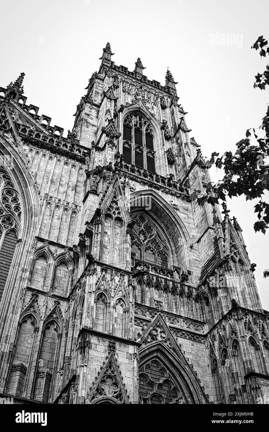 A black and white photograph of a gothic cathedral facade with ...
