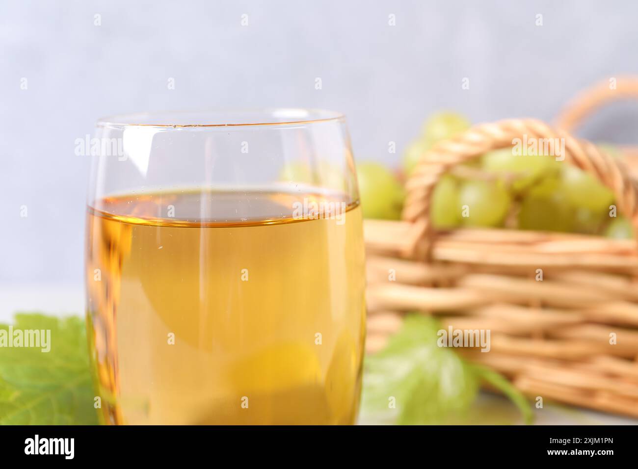 Tasty grape juice in glass on blurred background, closeup Stock Photo ...