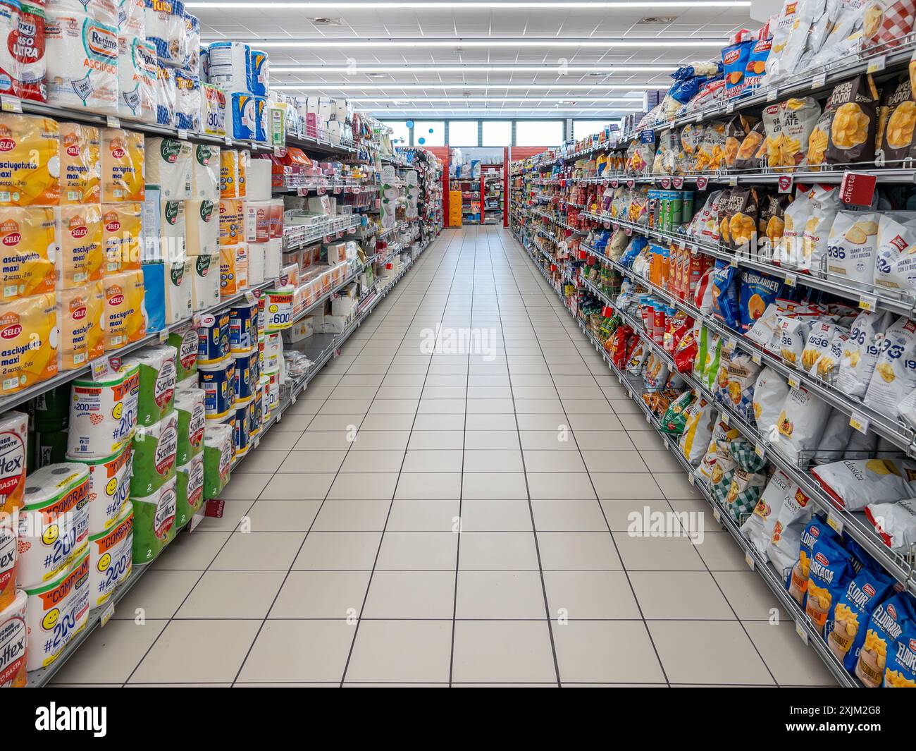 Italy - June 19, 2024: Aisle with shelves with snacks and chips on the ...