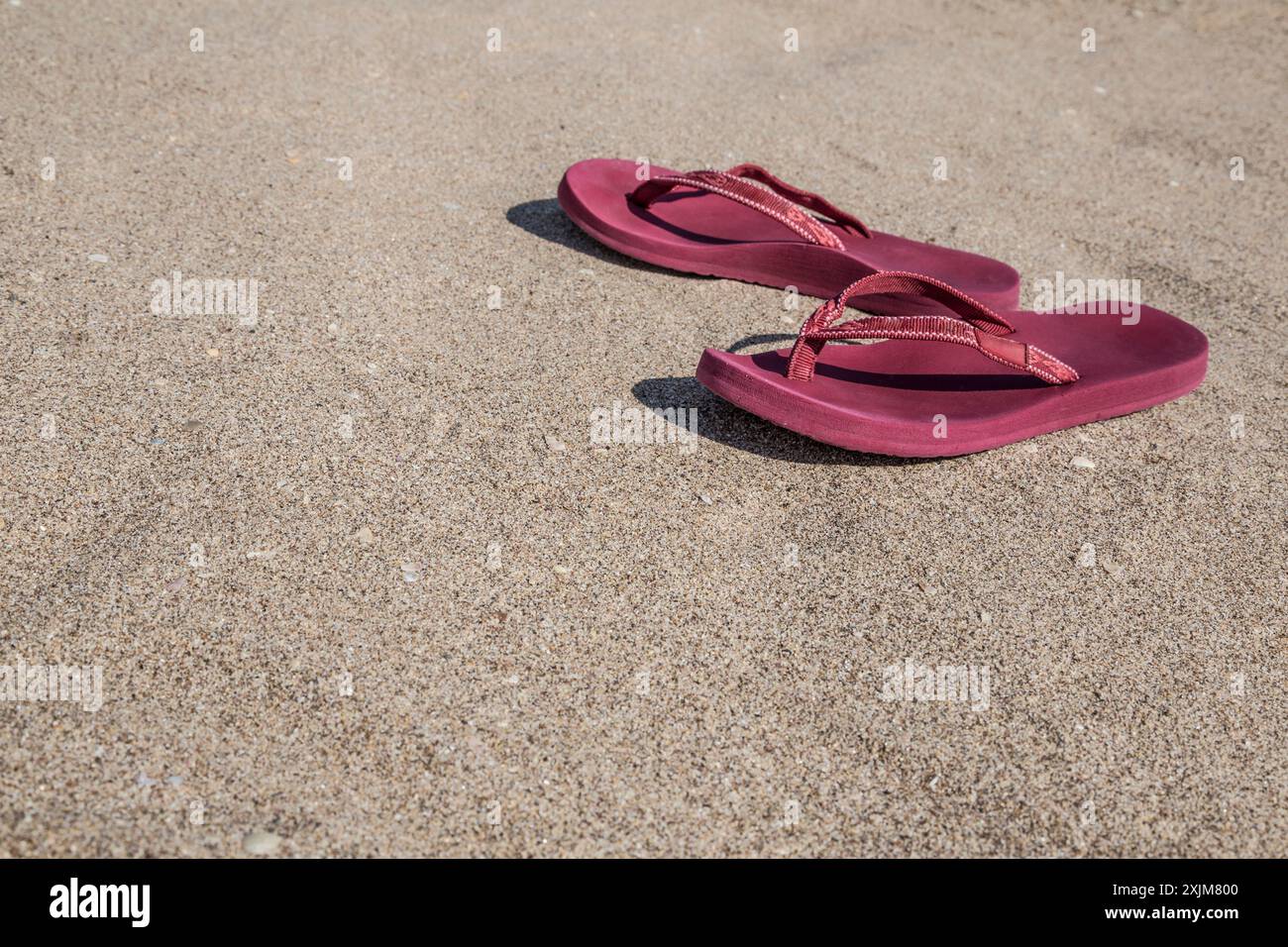Red flip flops on a sandy beach Stock Photo - Alamy