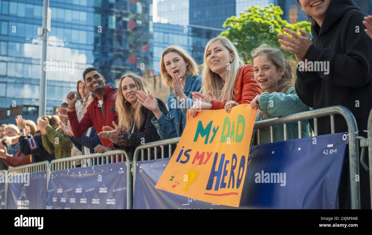 Little Girl and Her Mother Cheering for The Dad in the Audience of a ...