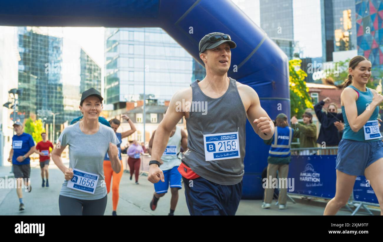 Portrait of Smiling Middle Aged Man Running in a City Marathon, Waving ...