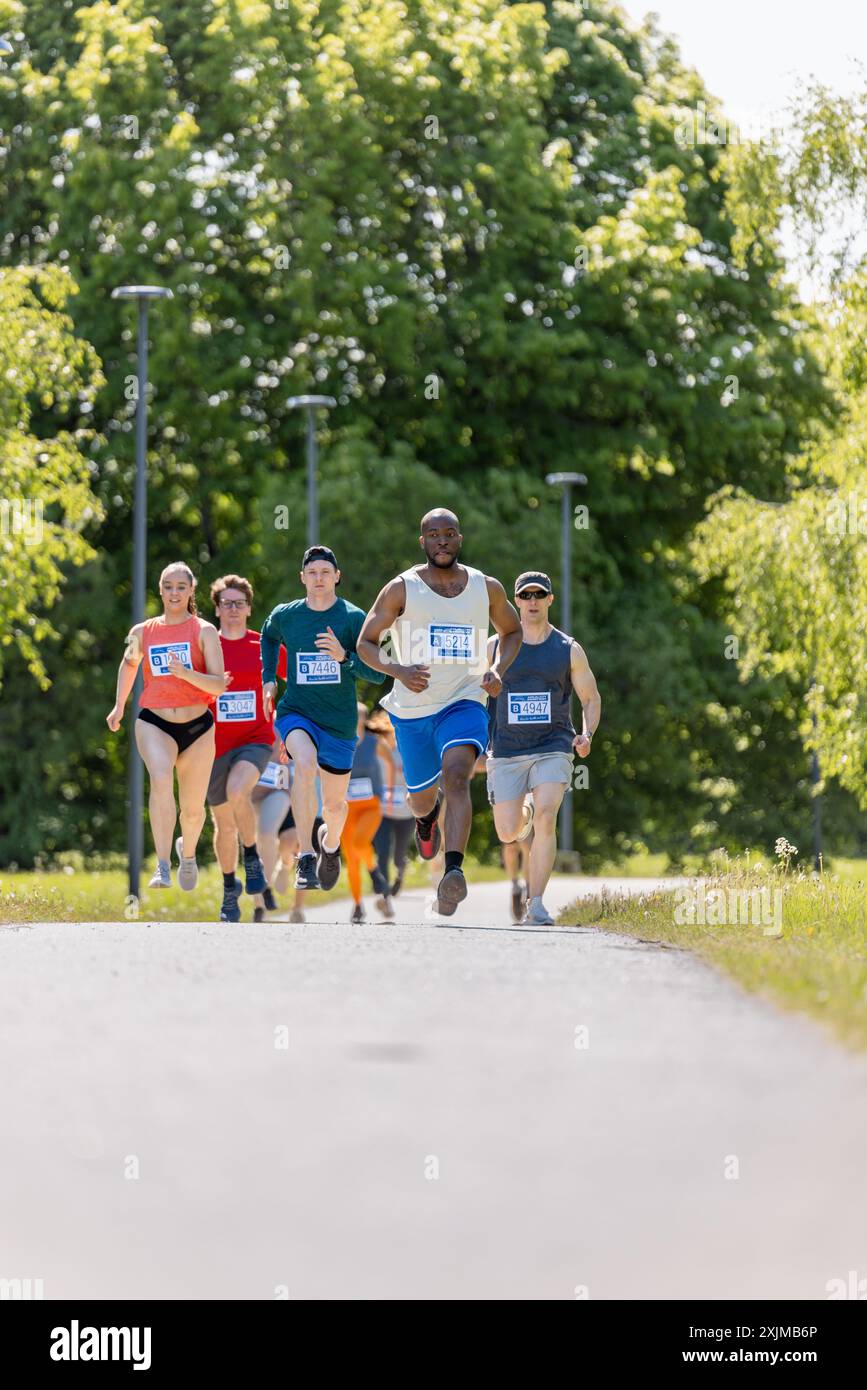 Wide Shot of Diverse Marathon Participants Competing in a Race for the ...