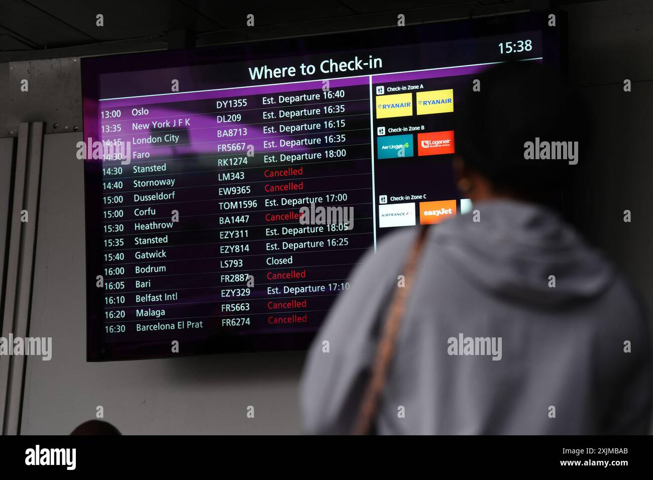 A person views a check-in display at Edinburgh Airport, as widespread IT outages affecting ...