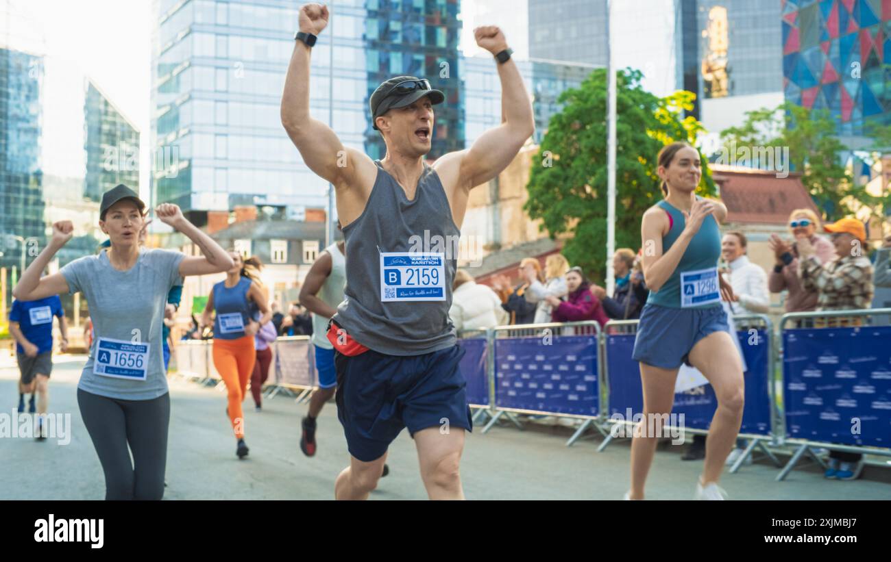 Portrait of Smiling Middle Aged Man Running in a City Marathon, Waving ...