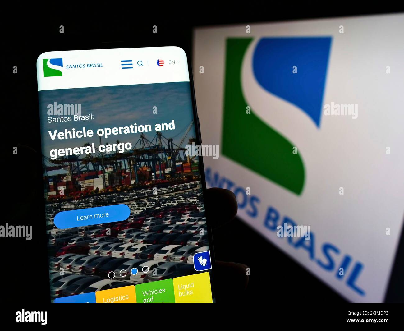 Stuttgart, Germany, 06-04-2022: Person holding smartphone with website of logistics company ...
