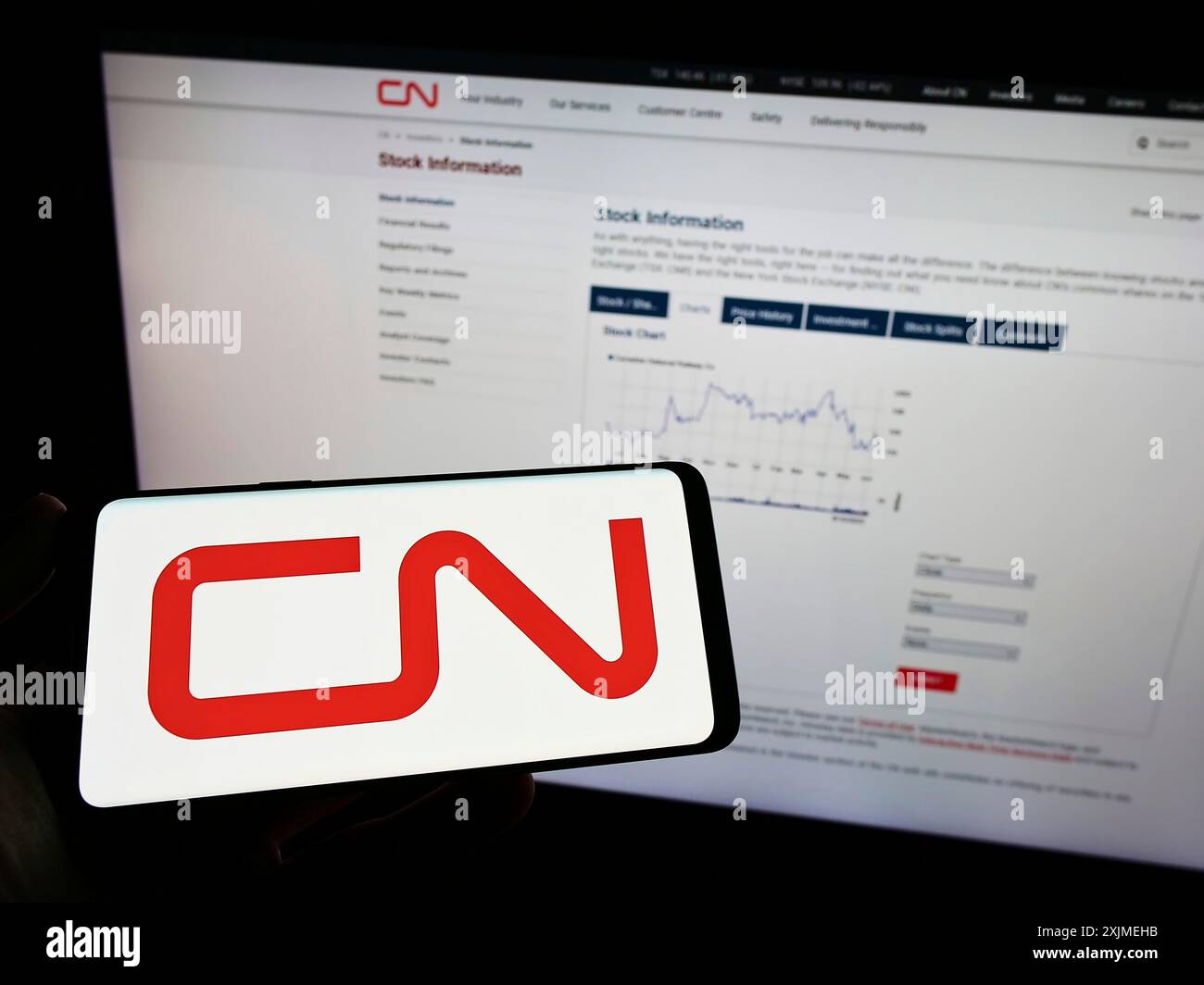 Stuttgart, Germany, 06-11-2022: Person holding mobile phone with logo of Canadian National ...