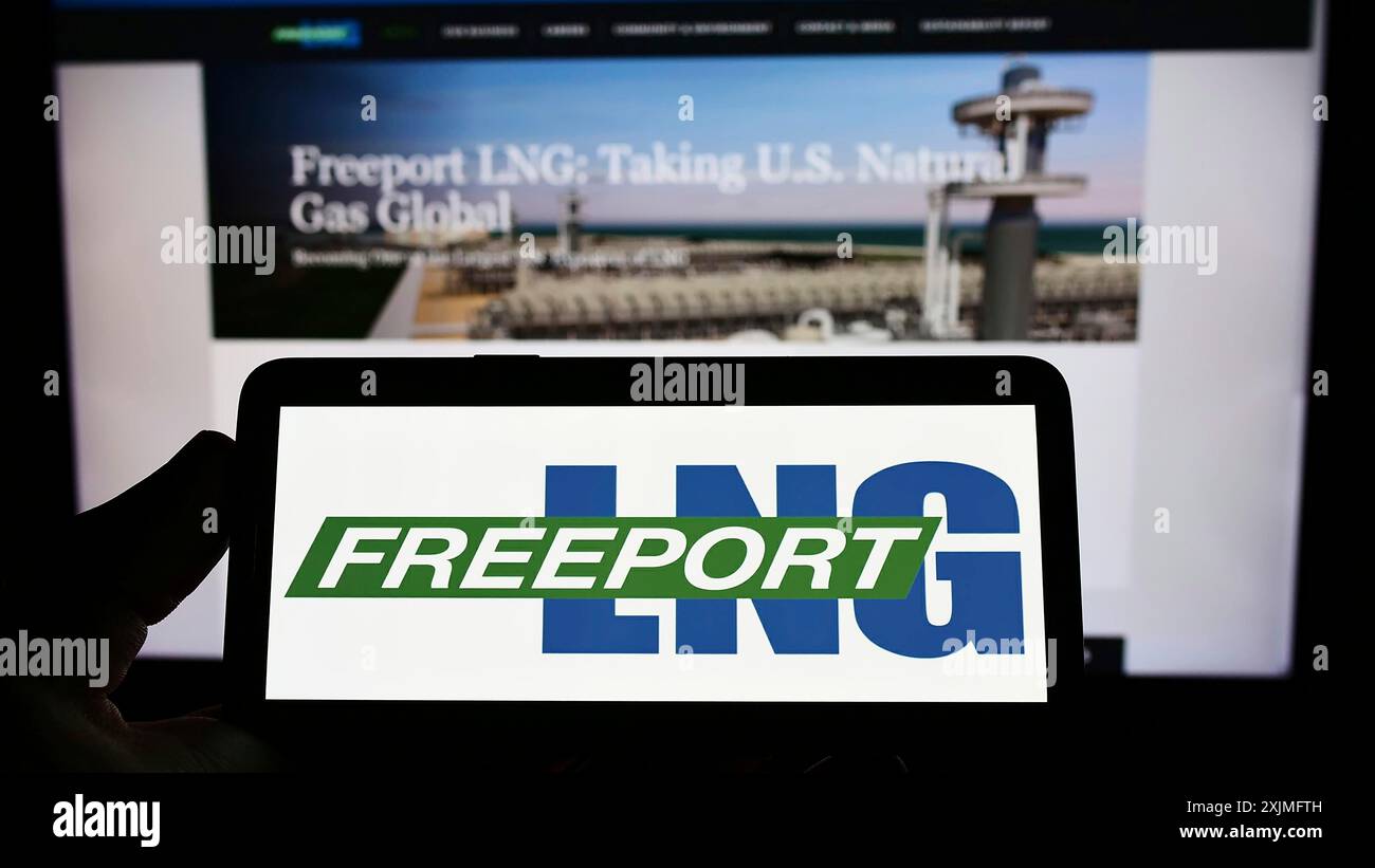 Stuttgart, Germany, 06-19-2022: Person holding mobile phone with logo of US gas company Freeport ...
