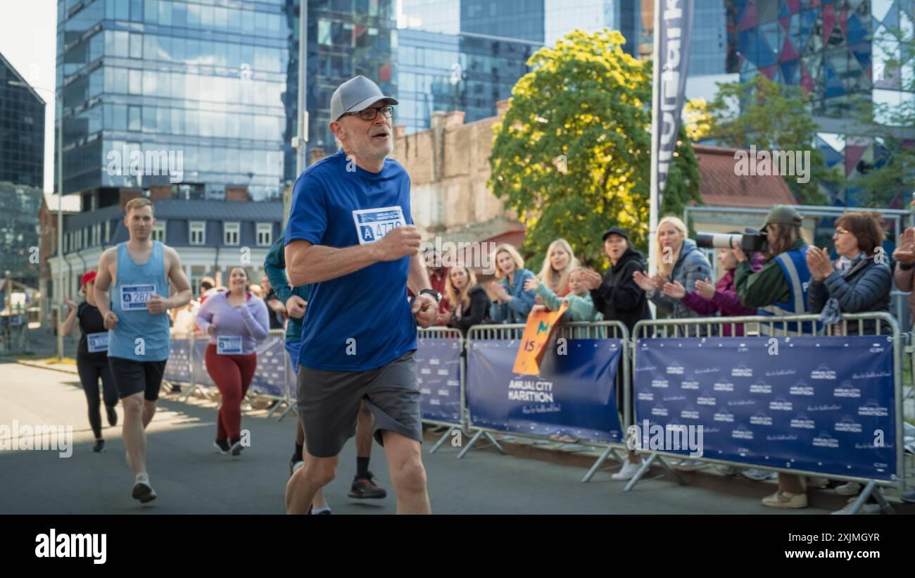 Portrait of a Senior Male Jogger Running in a City Marathon and Being ...