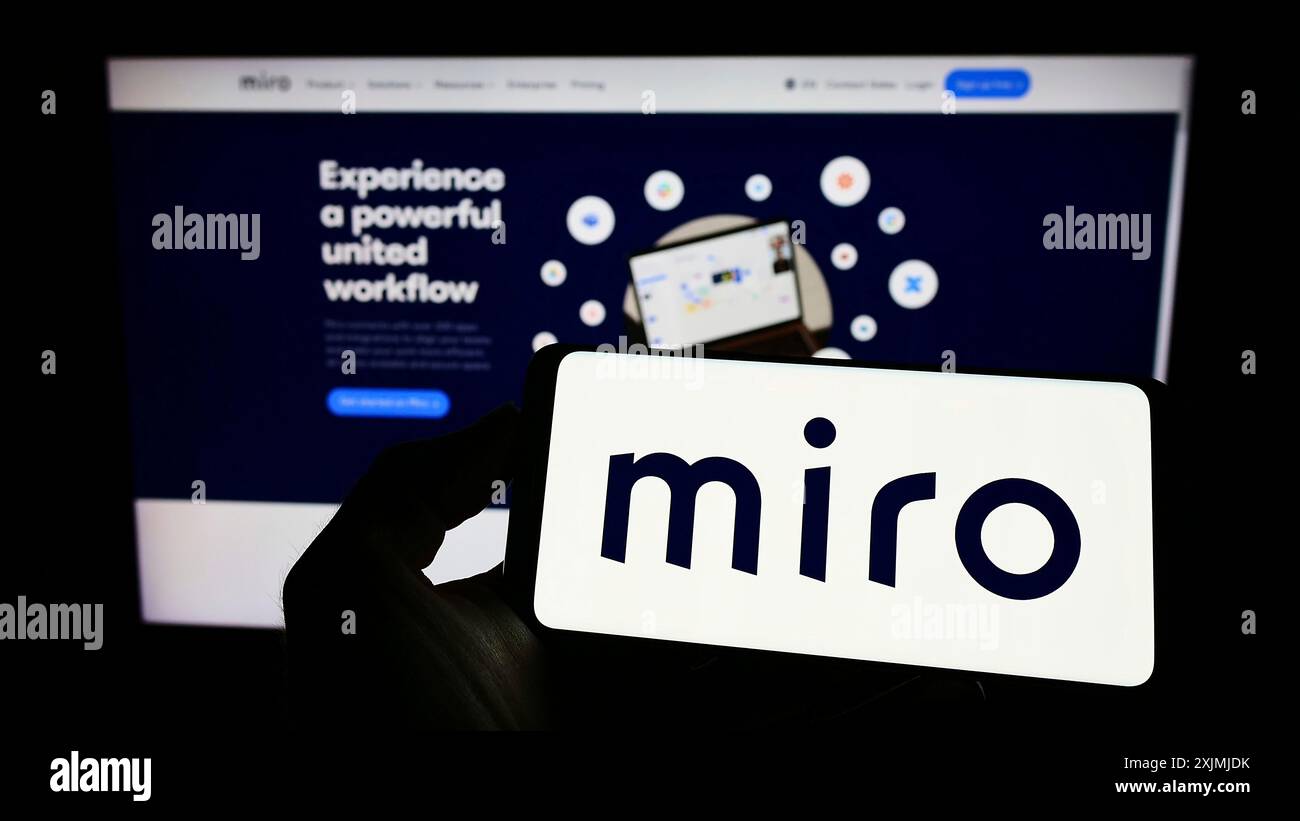 Stuttgart, Germany, 07-30-2022: Person holding mobile phone with logo of American software ...