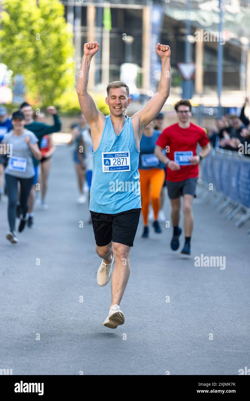Athletic Young Man Crossing the Finish Line in a City Marathon During ...