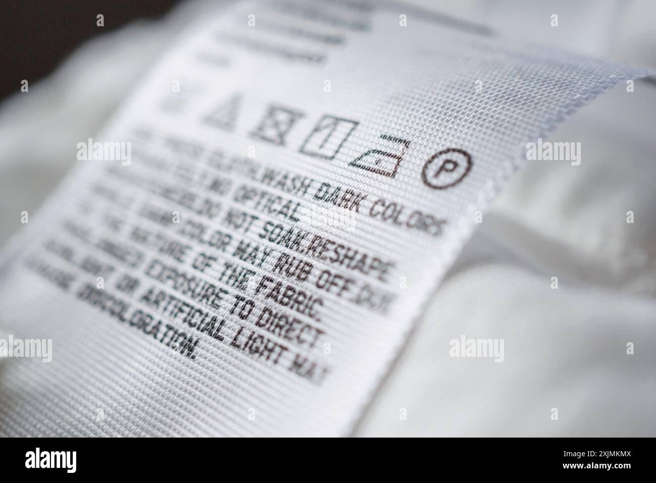 Cloth label tag with laundry care instructions Stock Photo - Alamy