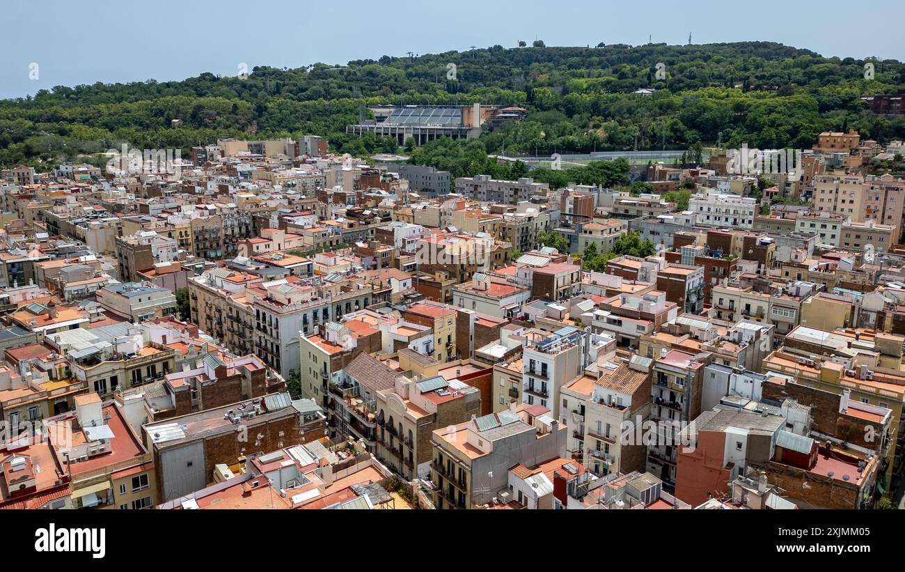 An aerial view with a drone over the middle of Barcelona and the roof ...