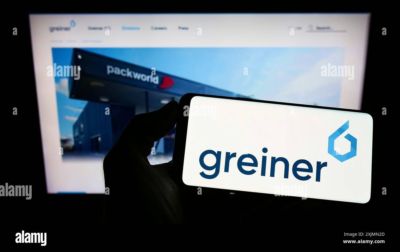 smartphone with logo of Austrian plastics company Greiner AG on screen ...