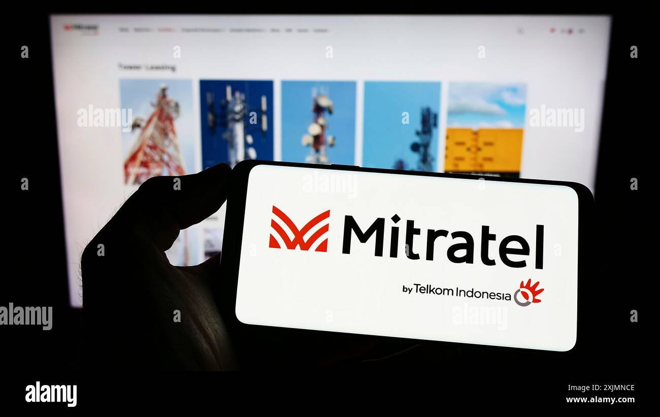 Stuttgart, Germany, 09-15-2022: Person holding cellphone with logo of PT Dayamitra ...