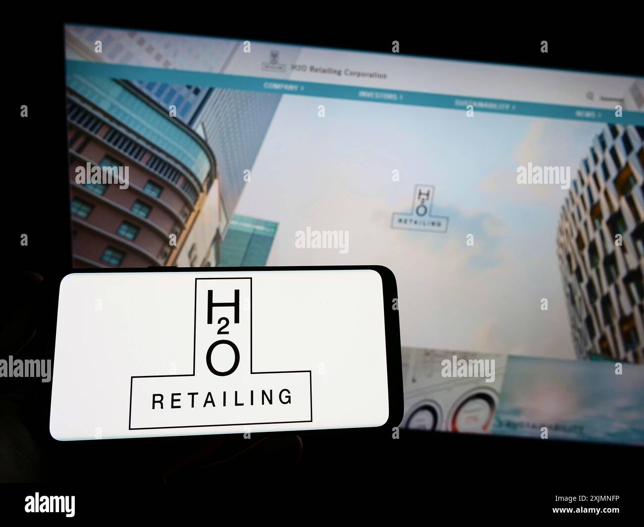 Stuttgart, Germany, 09-15-2022: Person holding smartphone with logo of Japanese company H2O ...