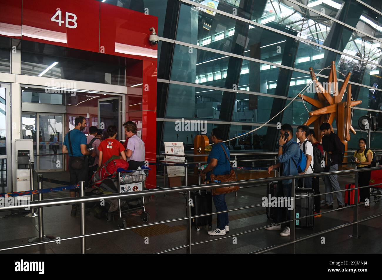 New Delhi, Delhi, India. 19th July, 2024. People wait in a queue to ...