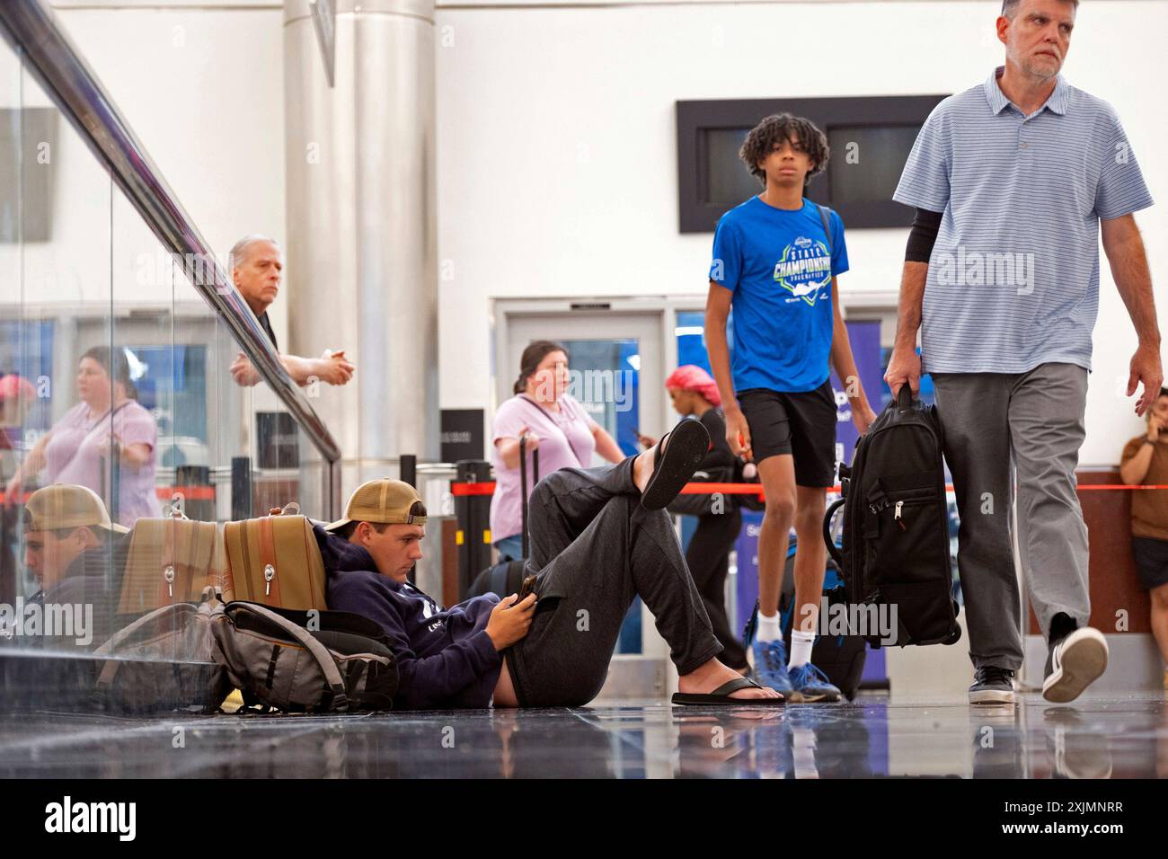 Andrew Colwell waits on his fourth rebooked flight as he tries to get ...