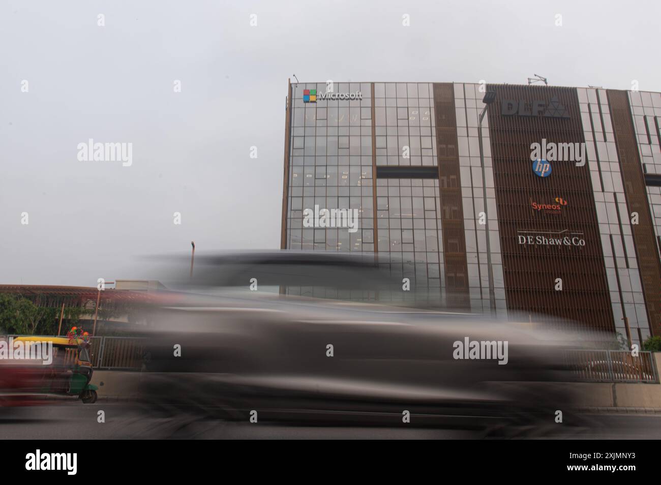 Gurugram, Haryana, India. 19th July, 2024. Vehicles move past an office ...