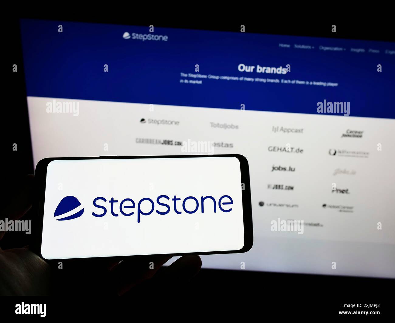 Stuttgart, Germany, 09-25-2022: Person holding mobile phone with logo ...