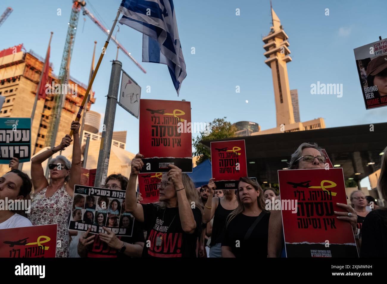 Placards with the motto “Secure a deal first, then fly", are shown ...